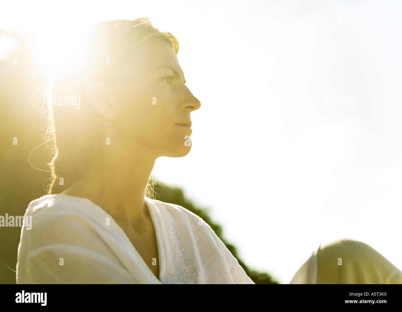 Woman in sun, profile Stock Photo - Alamy