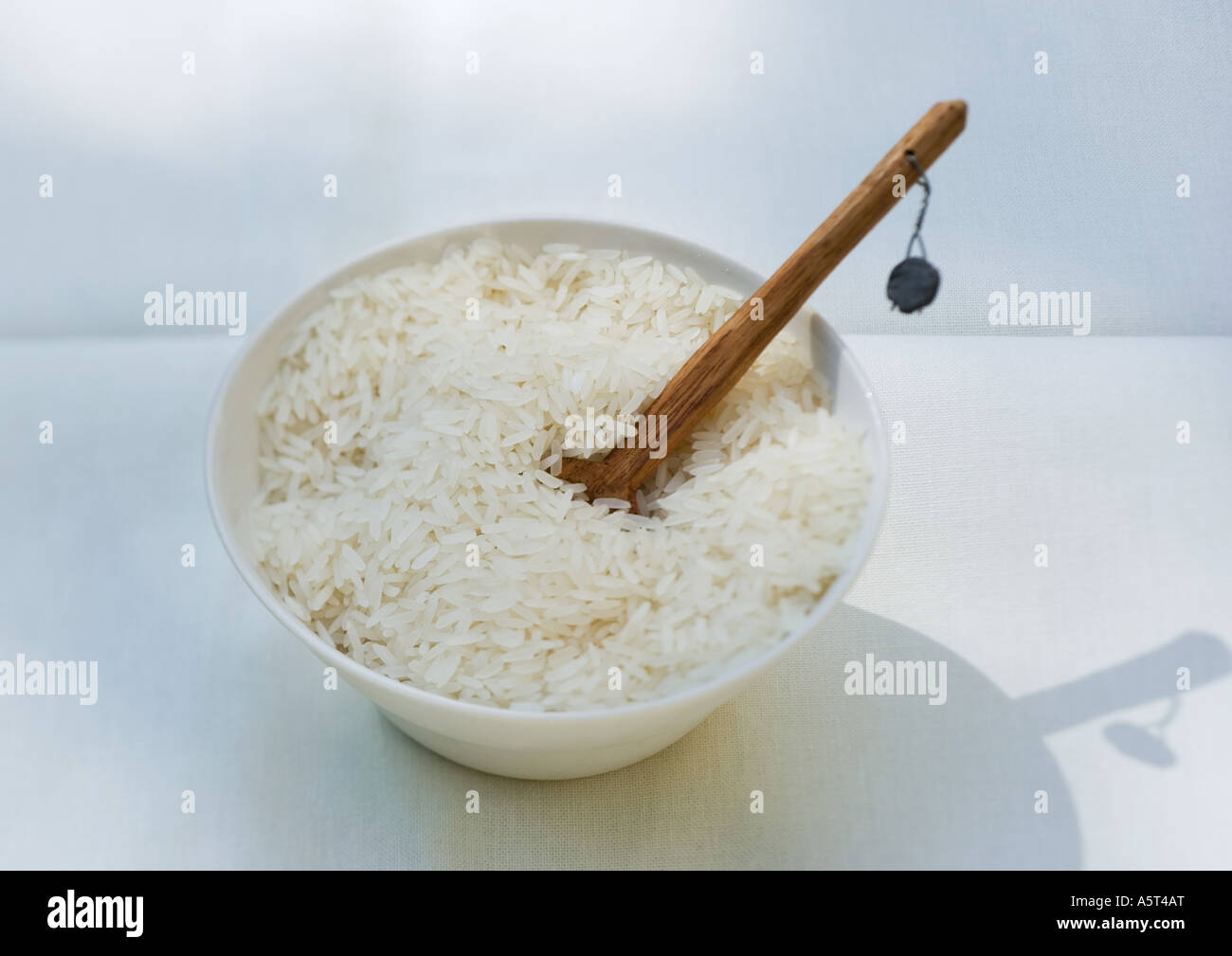 Bowl of rice and wooden spoon Stock Photo - Alamy