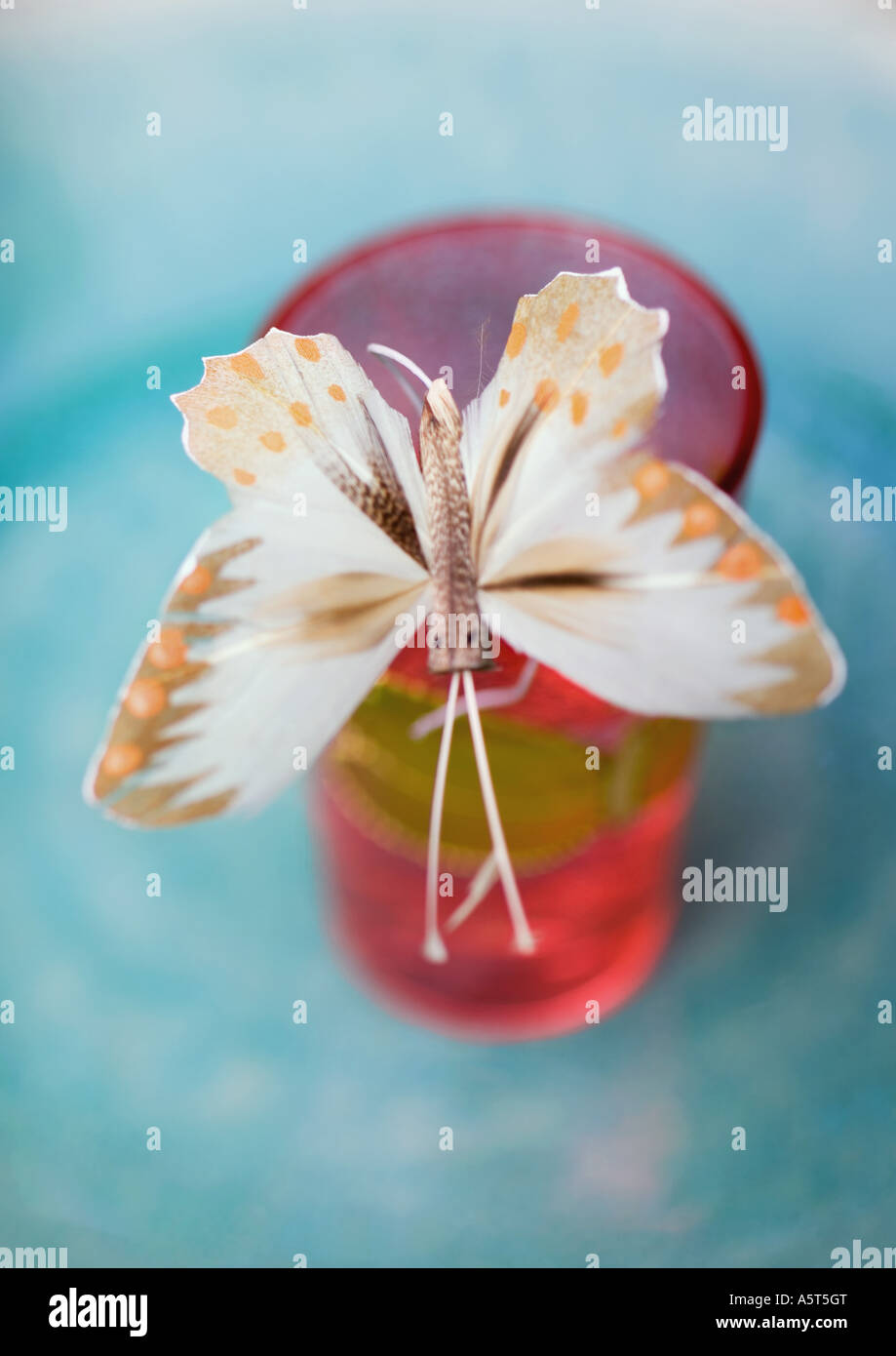 Fake butterfly on edge of glass Stock Photo - Alamy