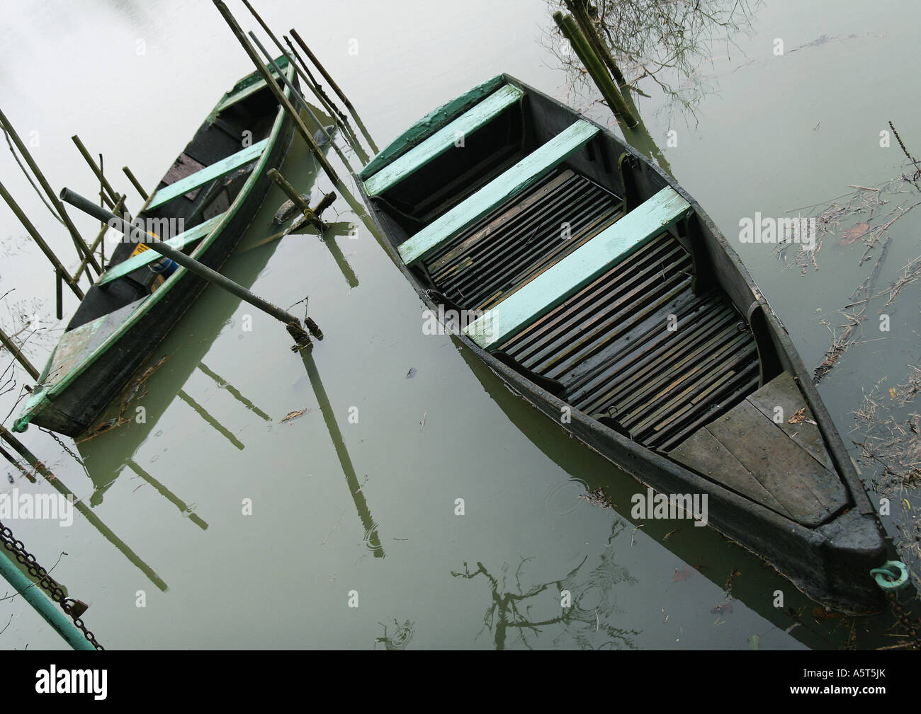 Rowboats floating in water, tilt Stock Photo - Alamy
