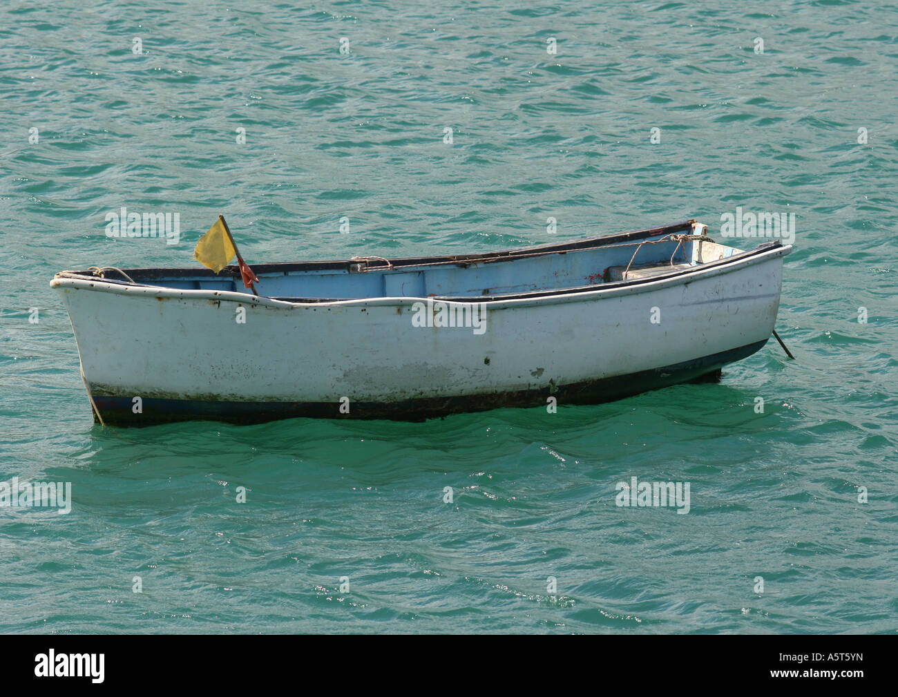 Empty rowboat in water Stock Photo - Alamy