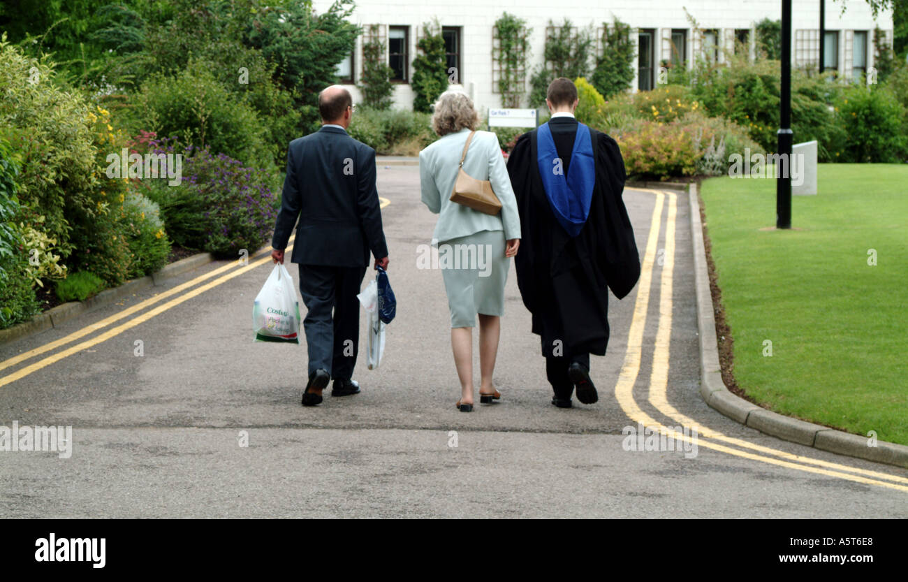New graduate leaves after graduation with parents Stock Photo - Alamy