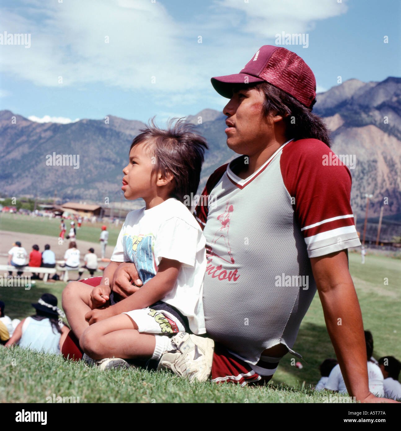 First Nations Canadian baseball player and his son watching a baseball ...