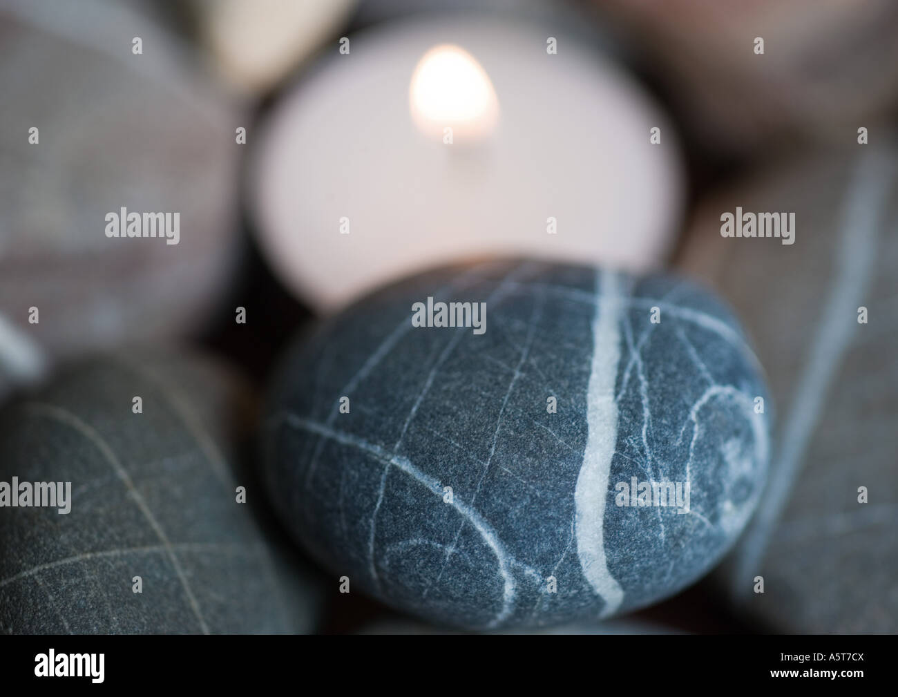 Candle and stones Stock Photo - Alamy