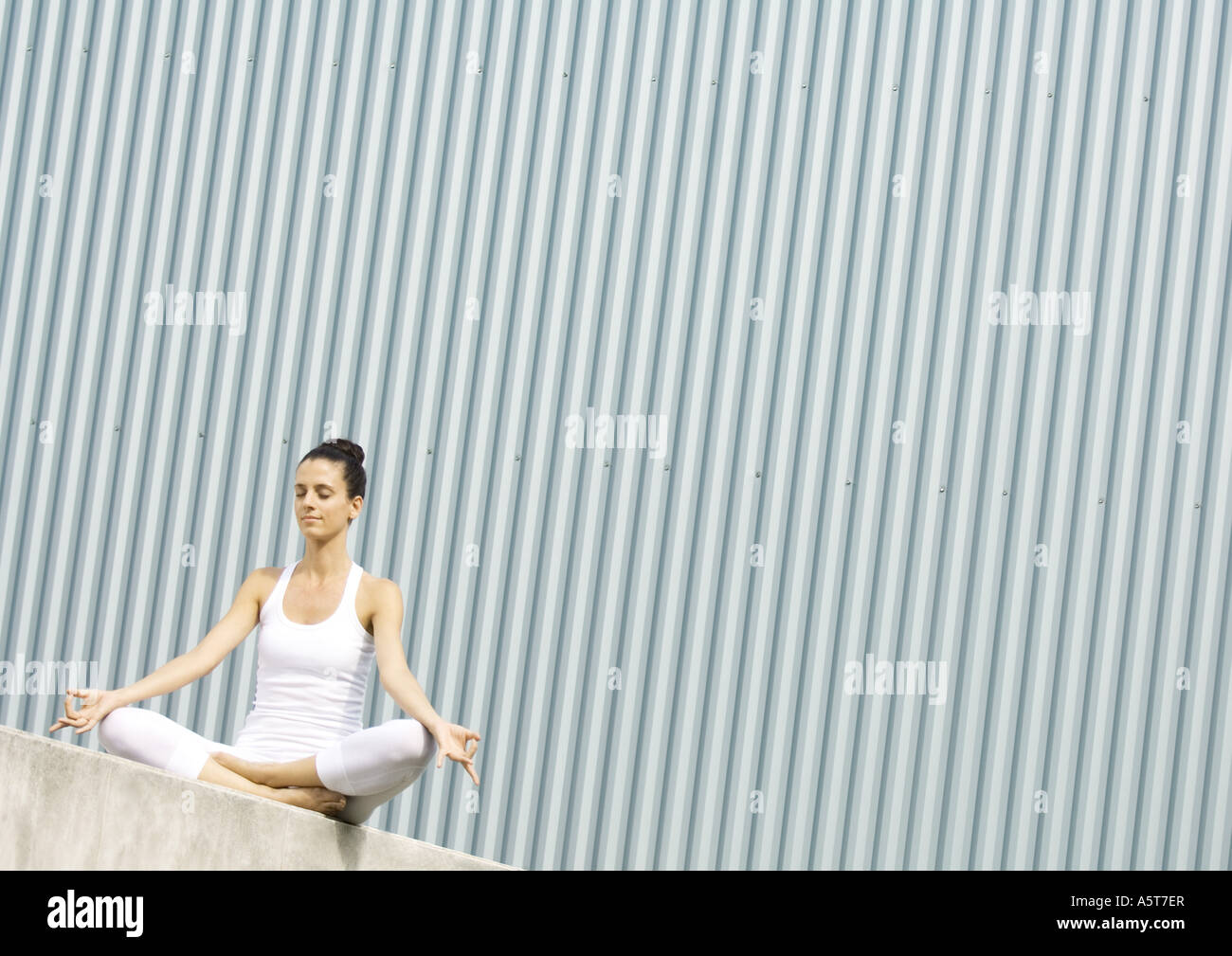 Woman sitting in lotus position Stock Photo - Alamy