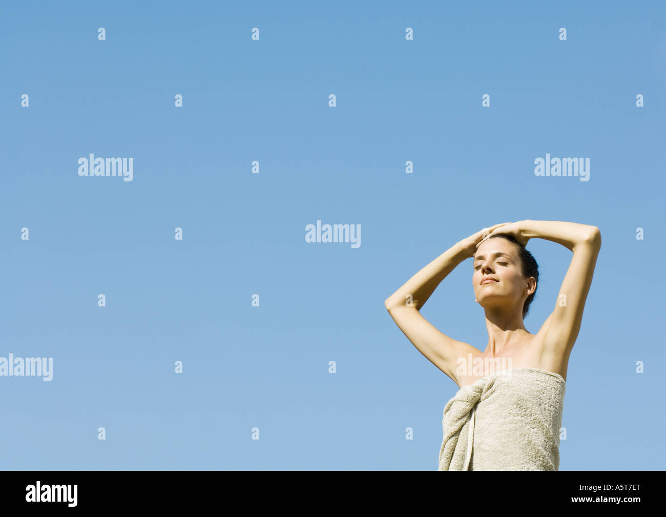 Woman standing with hands on head Stock Photo - Alamy