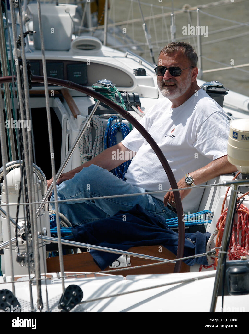 Skipper enjoying the sun on his ship Stock Photo - Alamy