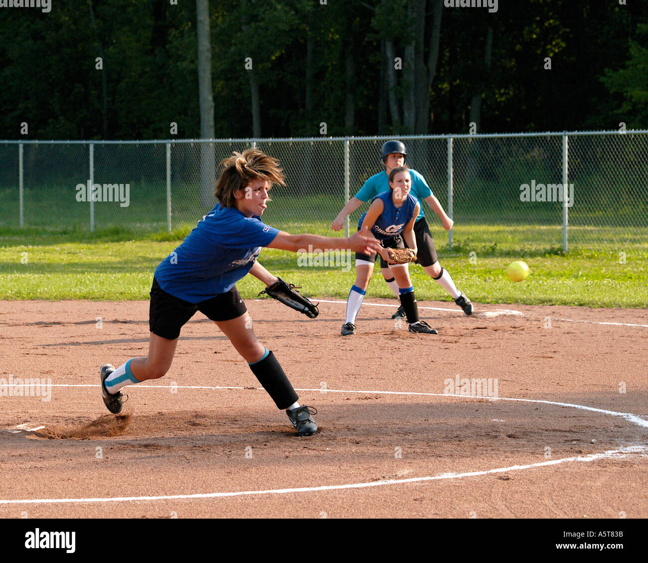 Youth girls softball pitcher in action Stock Photo - Alamy