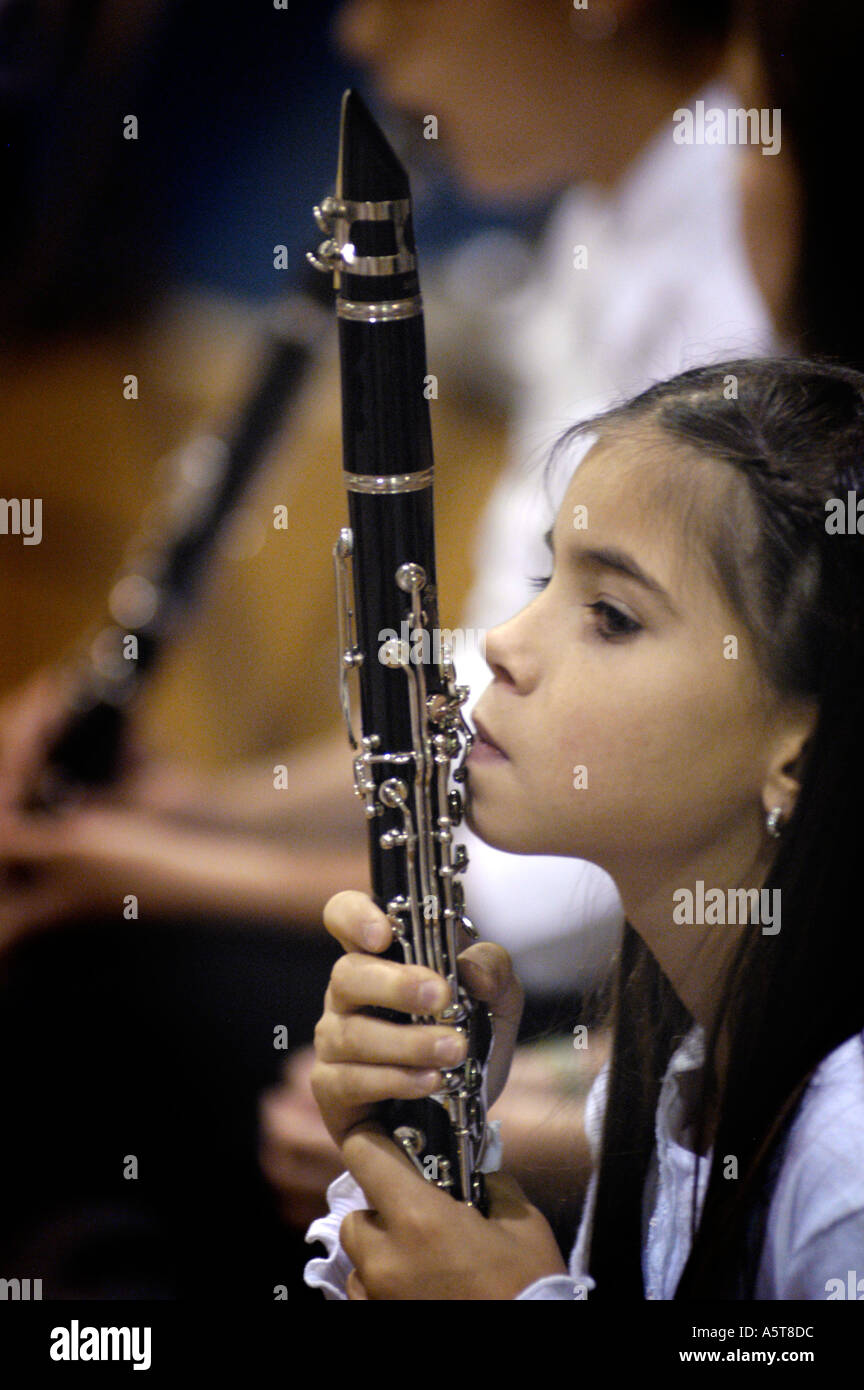 Girl face in a school band with her clarinet listening to band leader ...