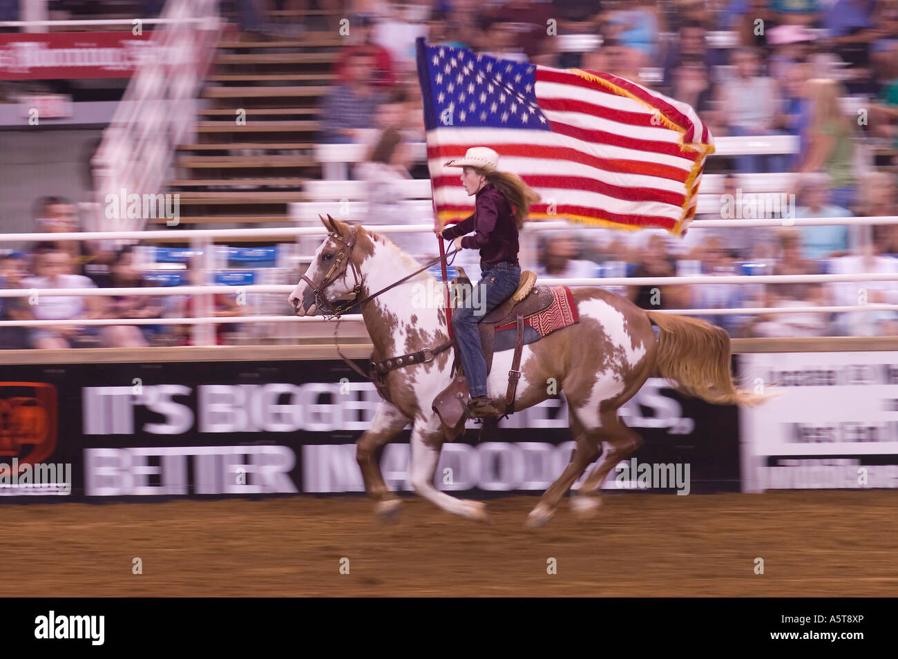 A Texan Cowgirl Rides with the American Flag during the Intro to a ...