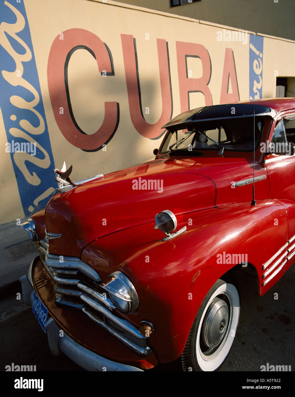 Red vintage car set against a street logo in Havana Cuba Stock Photo ...