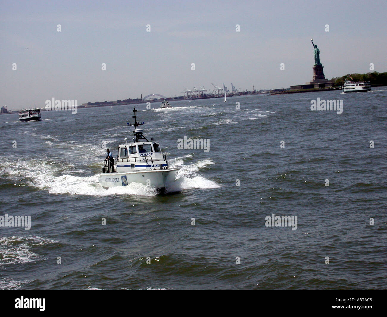 NYPD police boat guards the Statue of Liberty and New York Harbor Stock ...