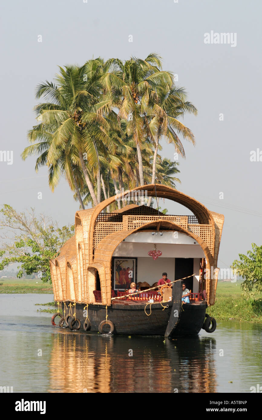 Tourists enjoy a serene evening cruise through the backwaters of Kerala ...