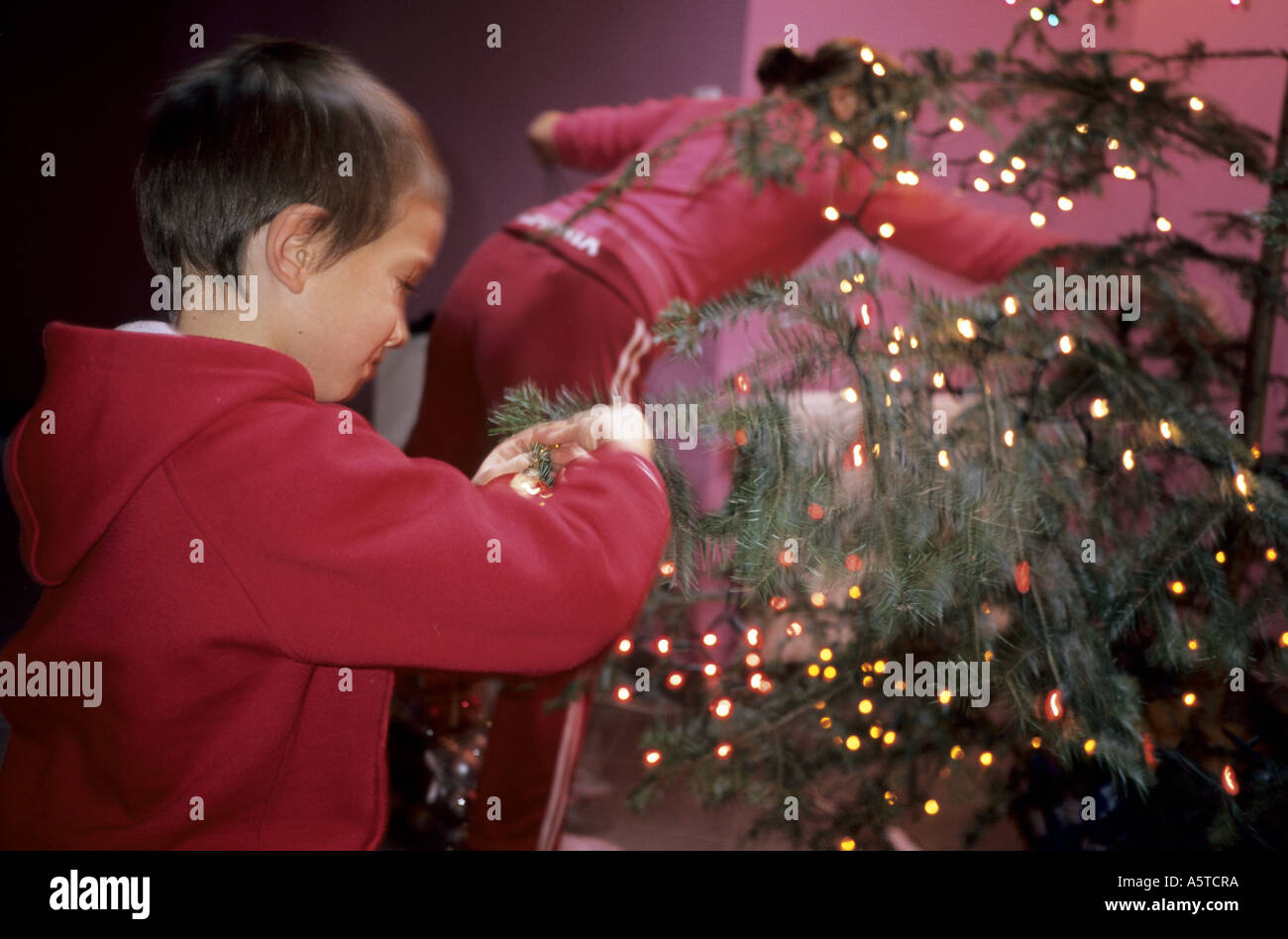 Poland, mom and son dressing up Christmas tree Stock Photo - Alamy