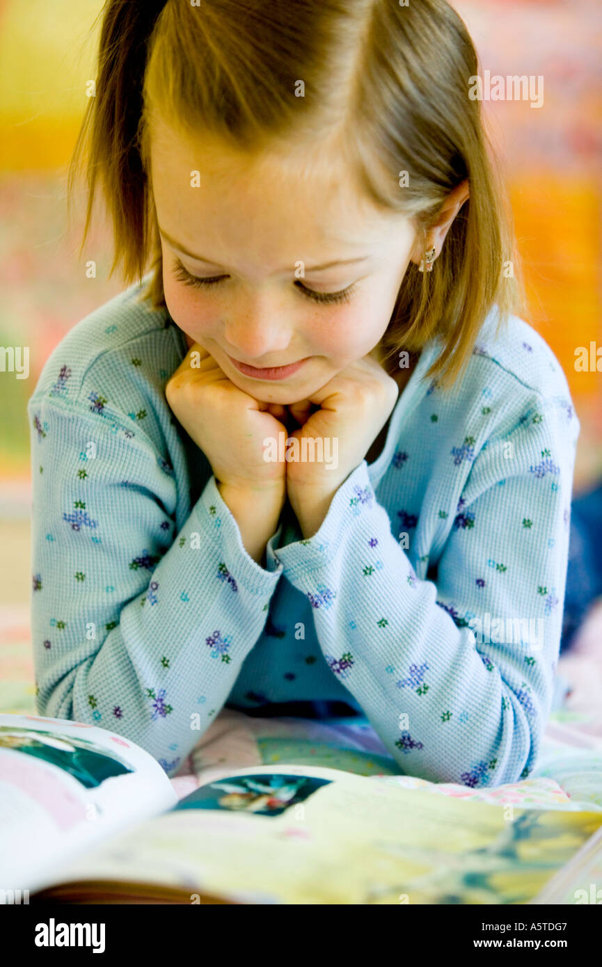 Kid Enjoying Reading Stock Photo - Alamy