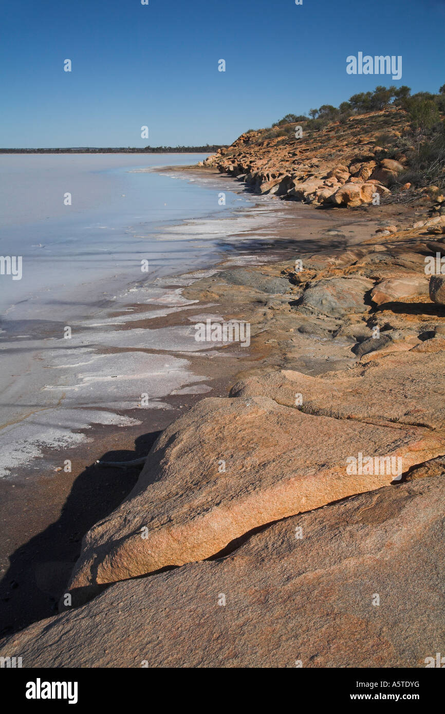 Australia granite rock outcrop sweeping down to shores of a salt lake ...
