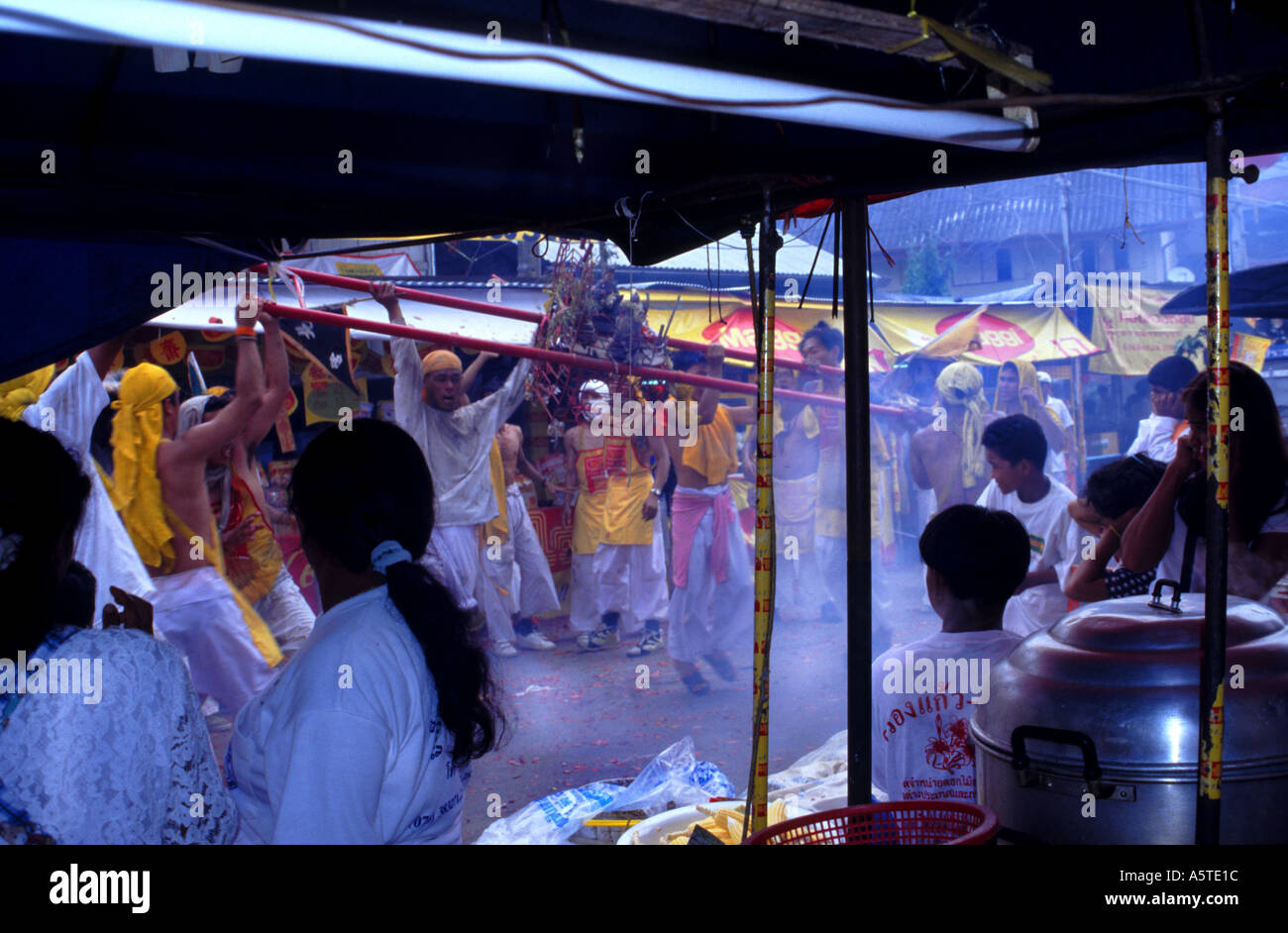 Firework smoke fills a lane of food stalls and eateries during the ...