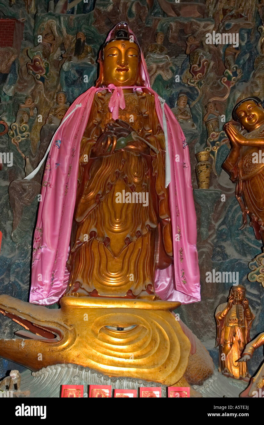 Statue of Lord Buddha riding on the head of a large fish, Jade Buddha ...