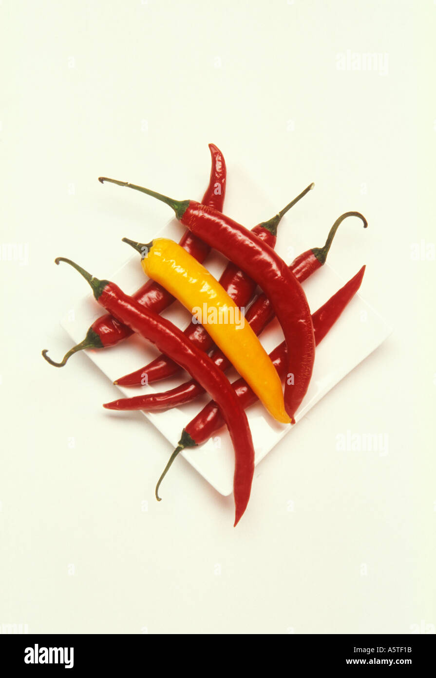 red yellow chili arranged on square plate cross hash pattern odd man ...