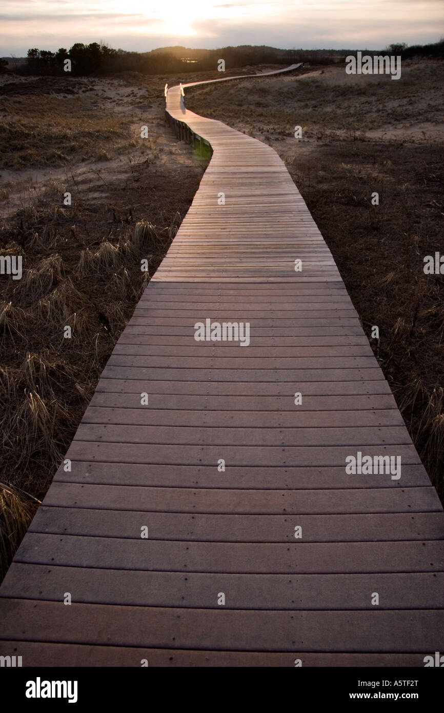 a Beach path through the sand dunes boardwalk walkway at sunset Stock ...