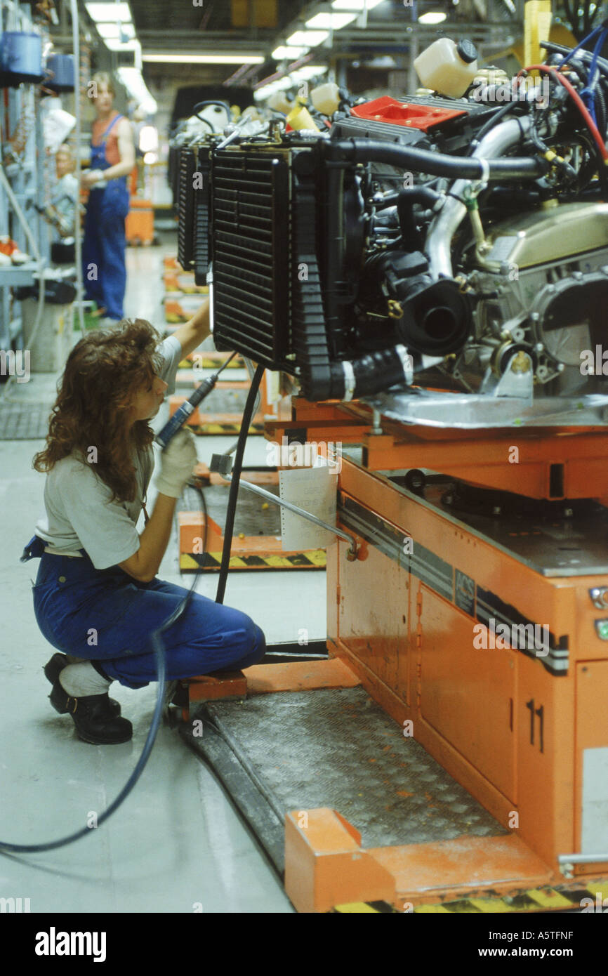 Woman working at Saab Plant with engines on automated trolleys in ...