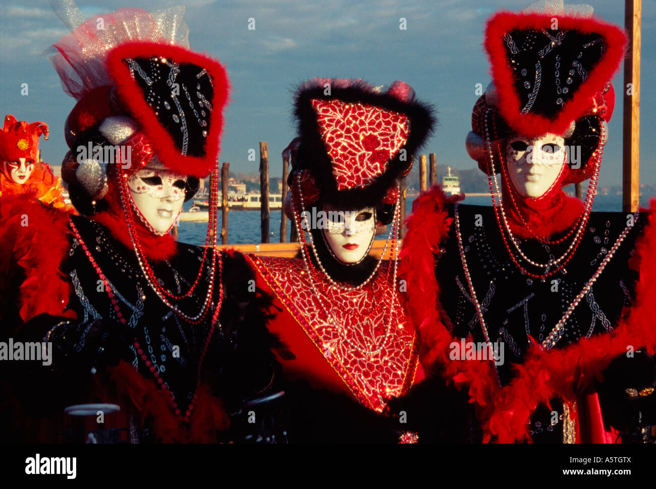 Carnival characters by canal Venice carnival Italy Stock Photo - Alamy