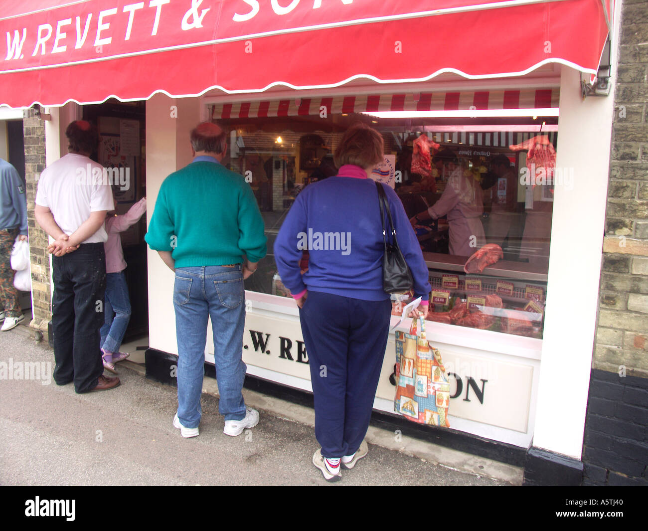 People queue outside traditional butcher shop Wickham Market Suffolk ...