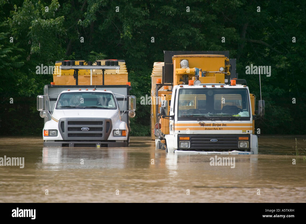 Flooding of Susquehanna River submerging utility trucks in commercial ...