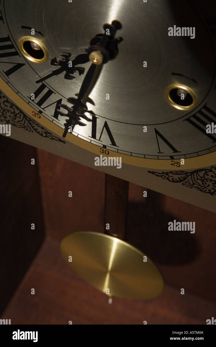 A Clock Face with a Pendulum Stock Photo - Alamy