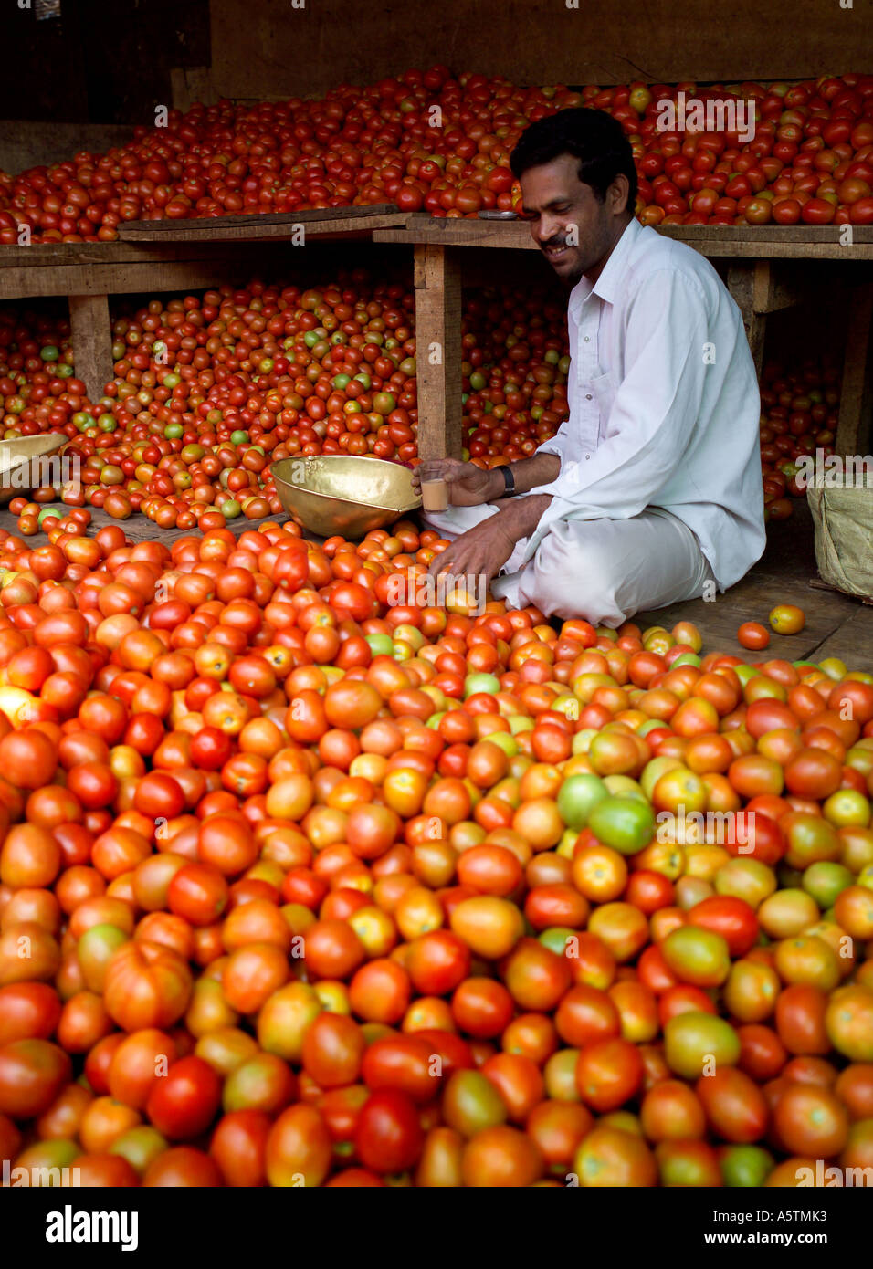 Man selling tomatoes, Devaraja Fruit and Vegetable Market, Mysore ...