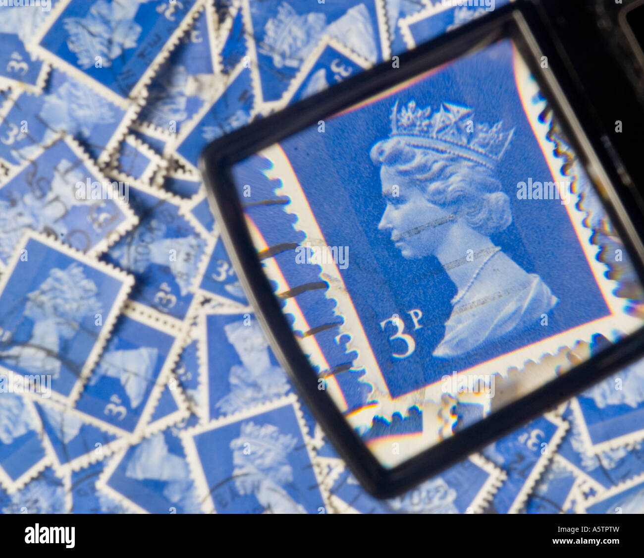 British 3p definitive stamps under a magnifying glass Stock Photo - Alamy