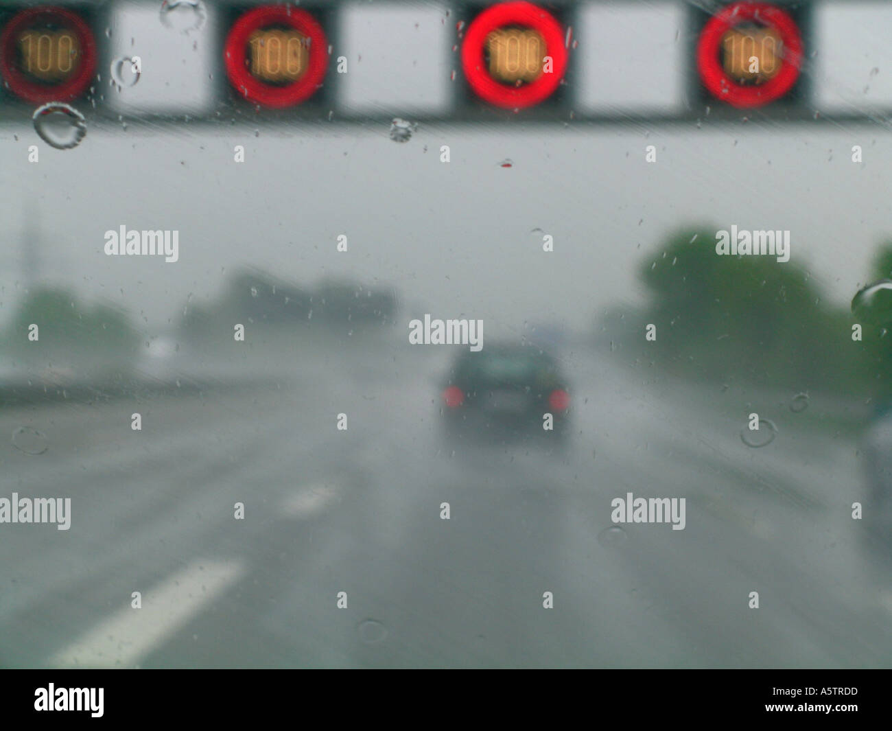 electric signs for speed limit above a moroway with bad sight on rainy ...