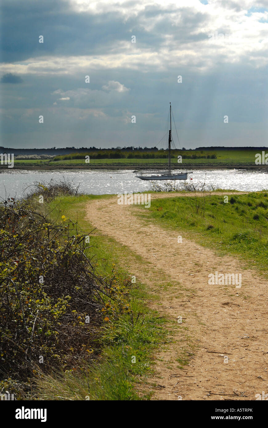 A walking path along the river Blackwater near Heybridge Basin in Essex ...