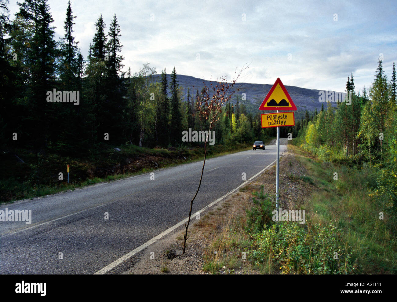 warning sign for bad road at the roadside at a country road in Lapland ...
