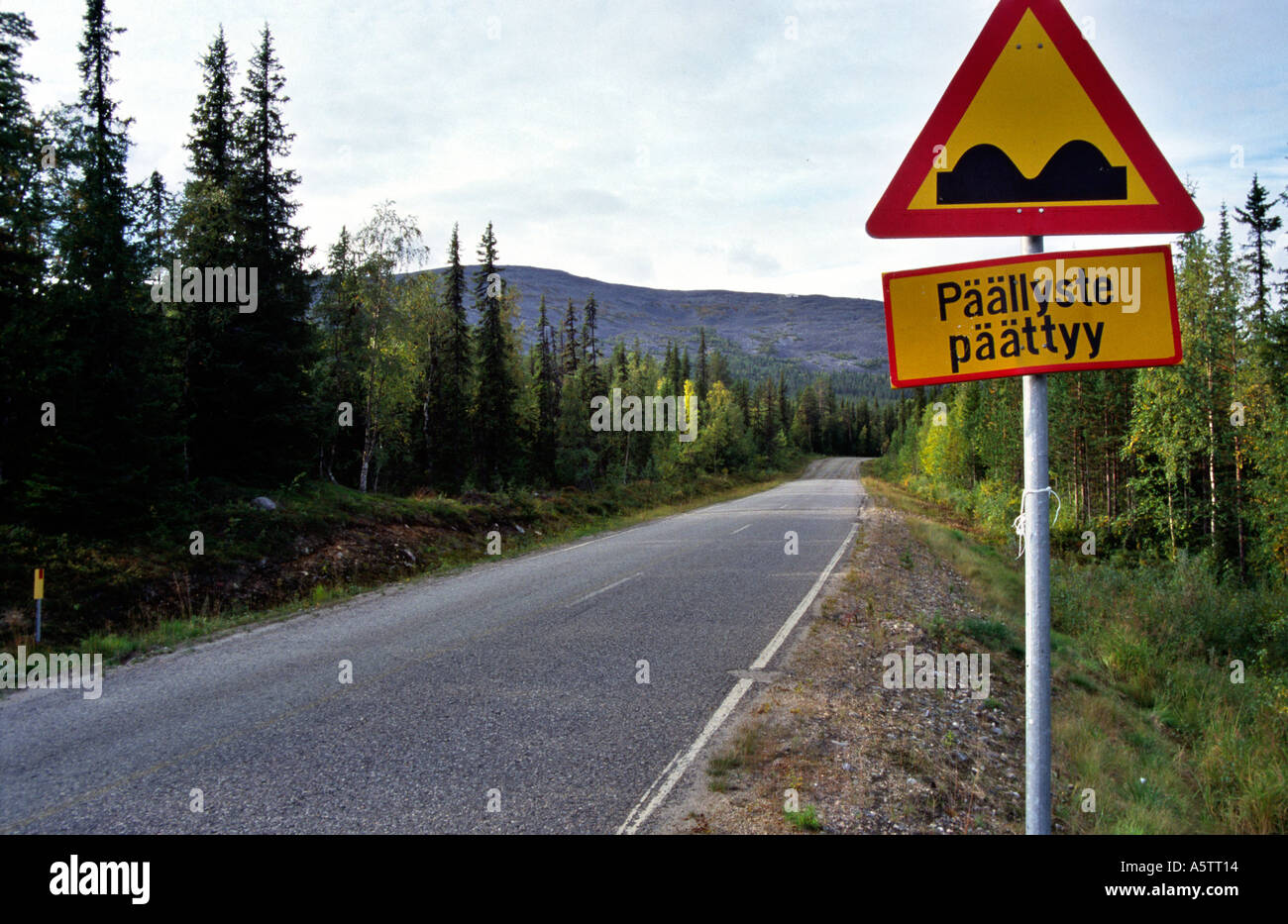 warning sign for bad road at the roadside at a country road in Lapland ...