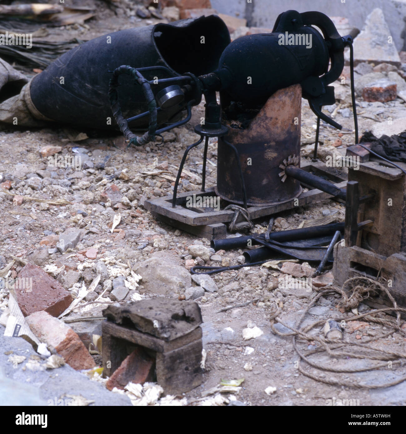 Fire blackened traditional popcorn making machine at a muddy roadside ...