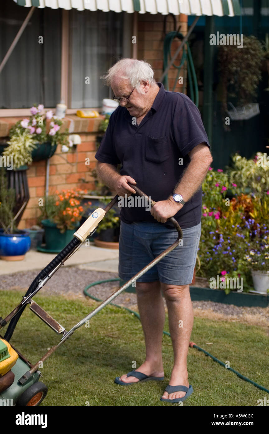 Old Man mowing the lawn Stock Photo - Alamy
