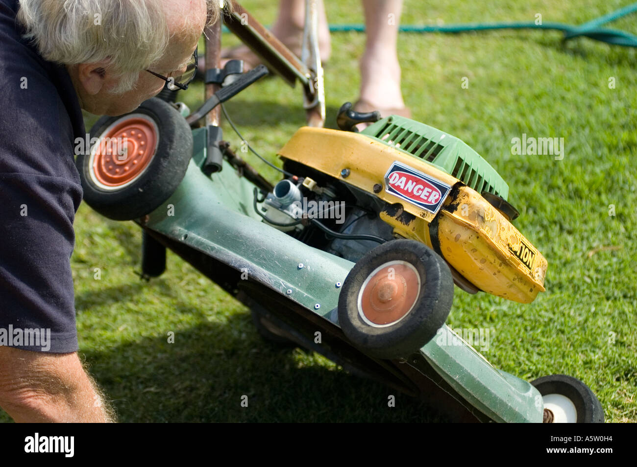 Old Man with lawn mower Stock Photo - Alamy