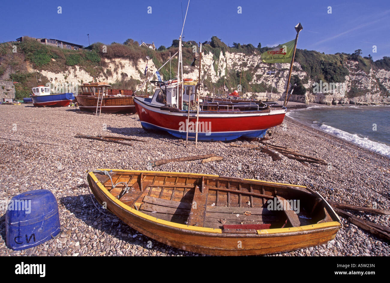 Beer, East Devon, Fishing boats are hauled by tractor up the beach ...