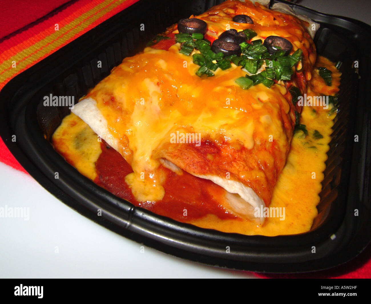 Enchiladas in a carryout container Stock Photo - Alamy