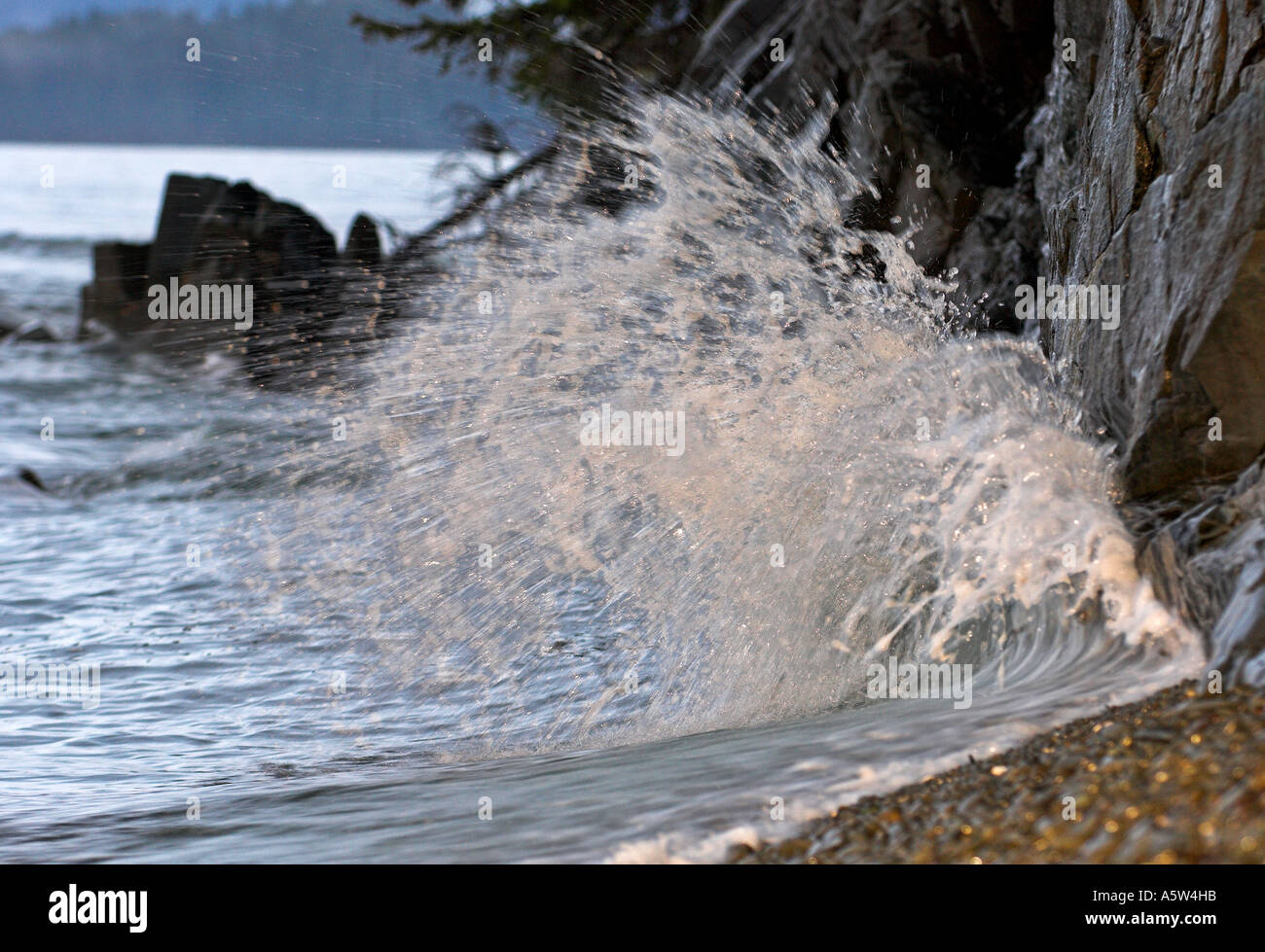 Waves crashing along shoreline Stock Photo - Alamy