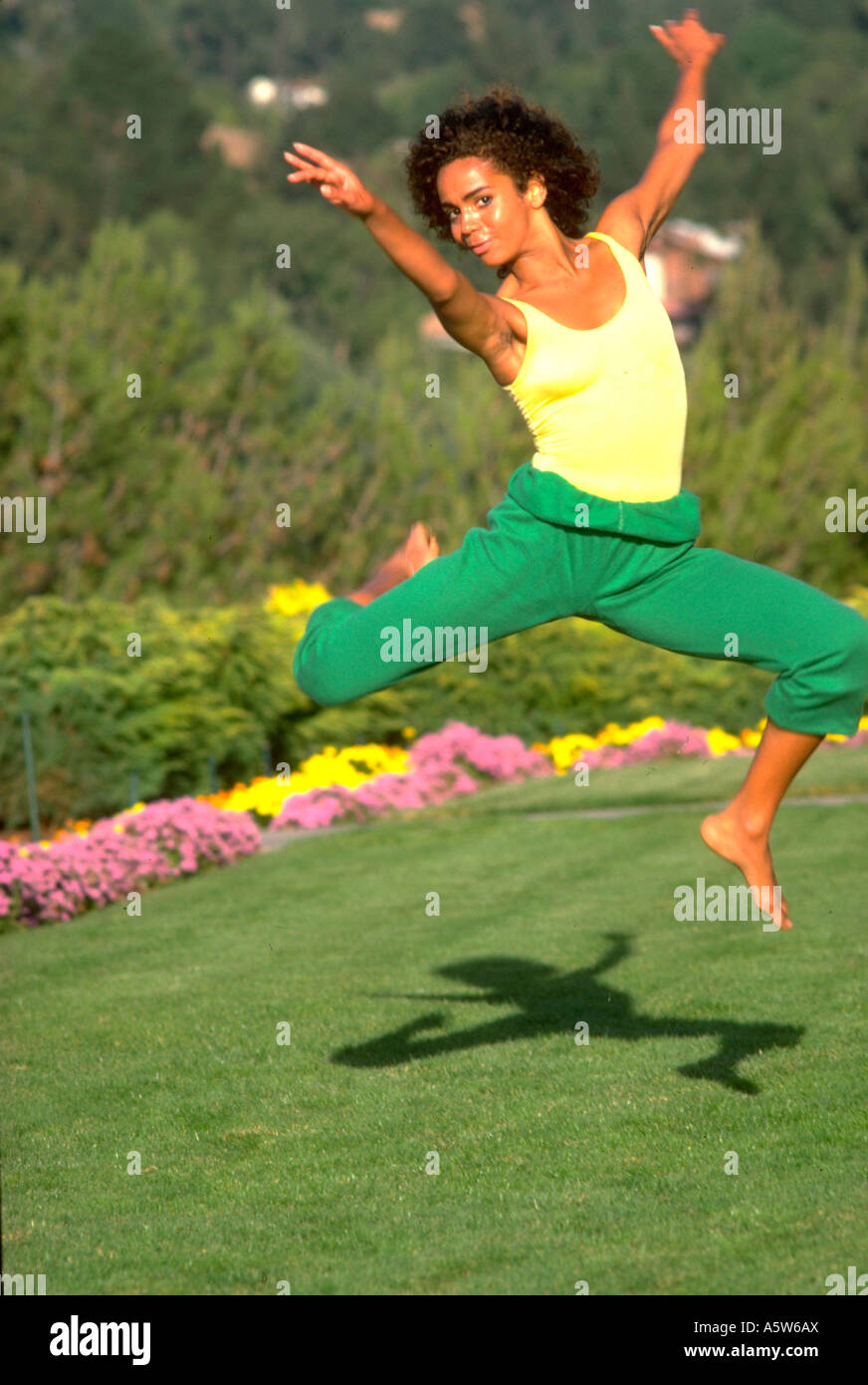 Woman leaping grass hi-res stock photography and images - Alamy