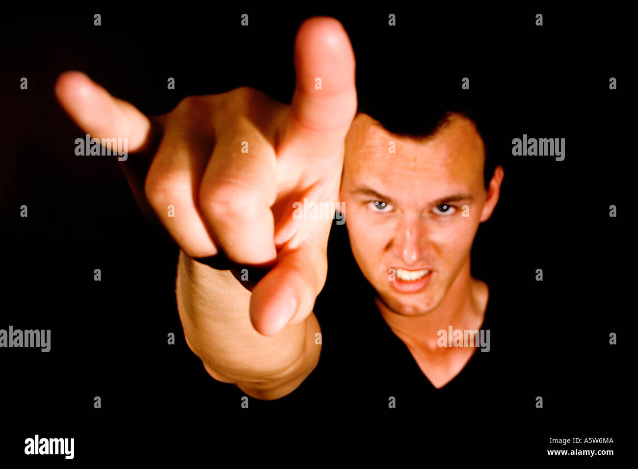 Man making the horn sign of the devil Stock Photo - Alamy