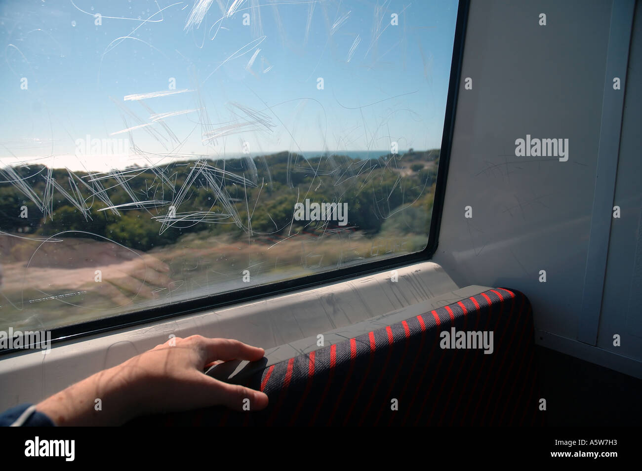 Graffiti scratched in window of suburban train Stock Photo - Alamy