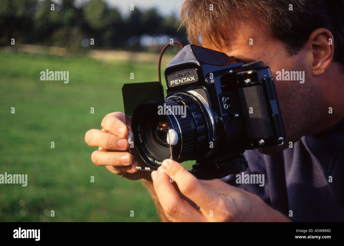 Photographer taking a picture Stock Photo - Alamy