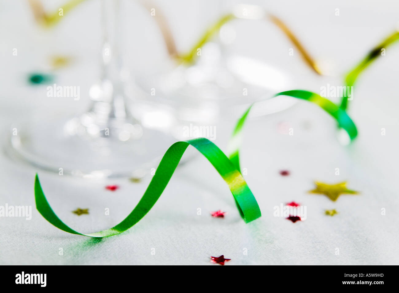 Streamers green and gold on table with star confetti and champagne wine ...