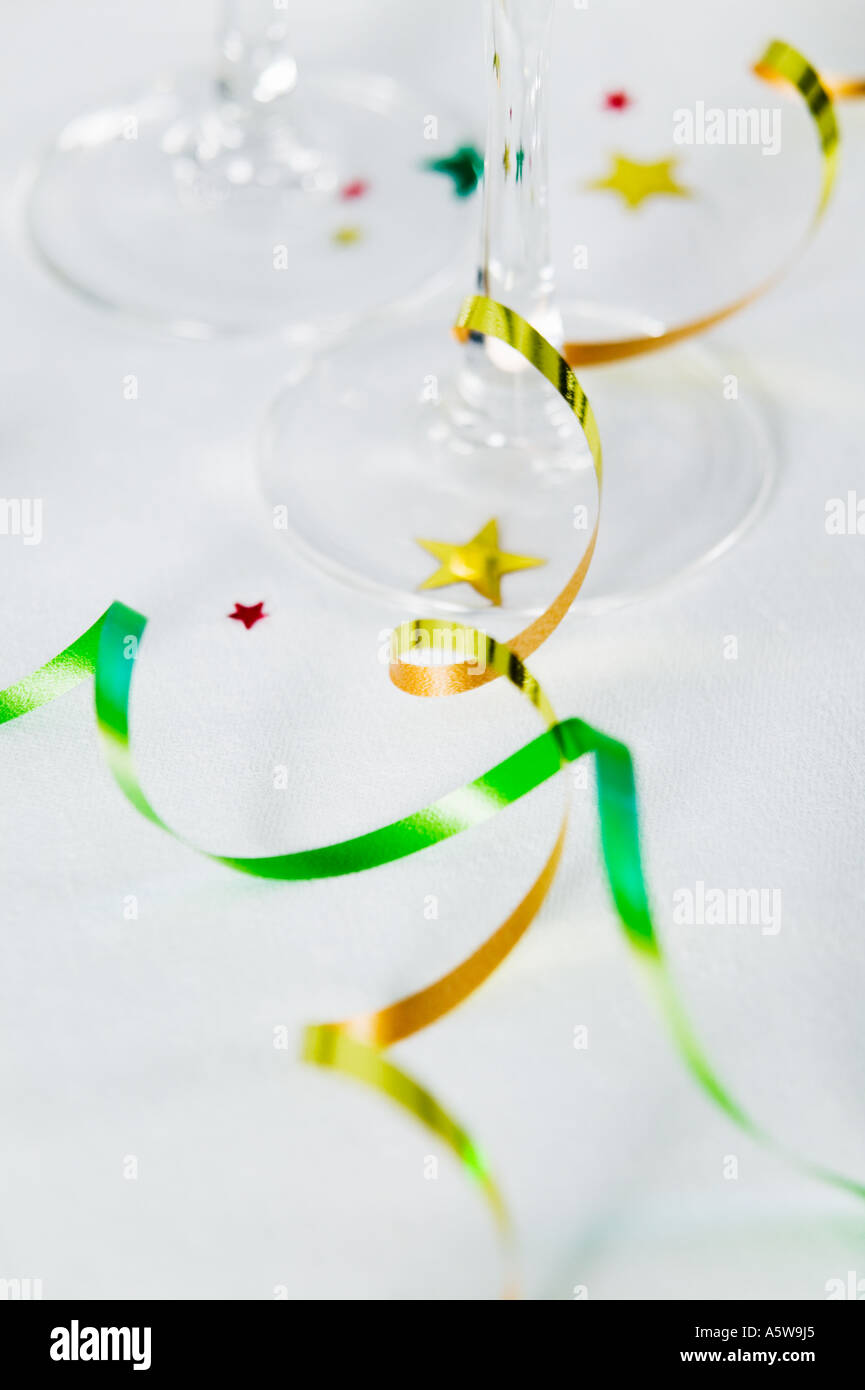 Streamers green and gold on table with star confetti and champagne wine ...