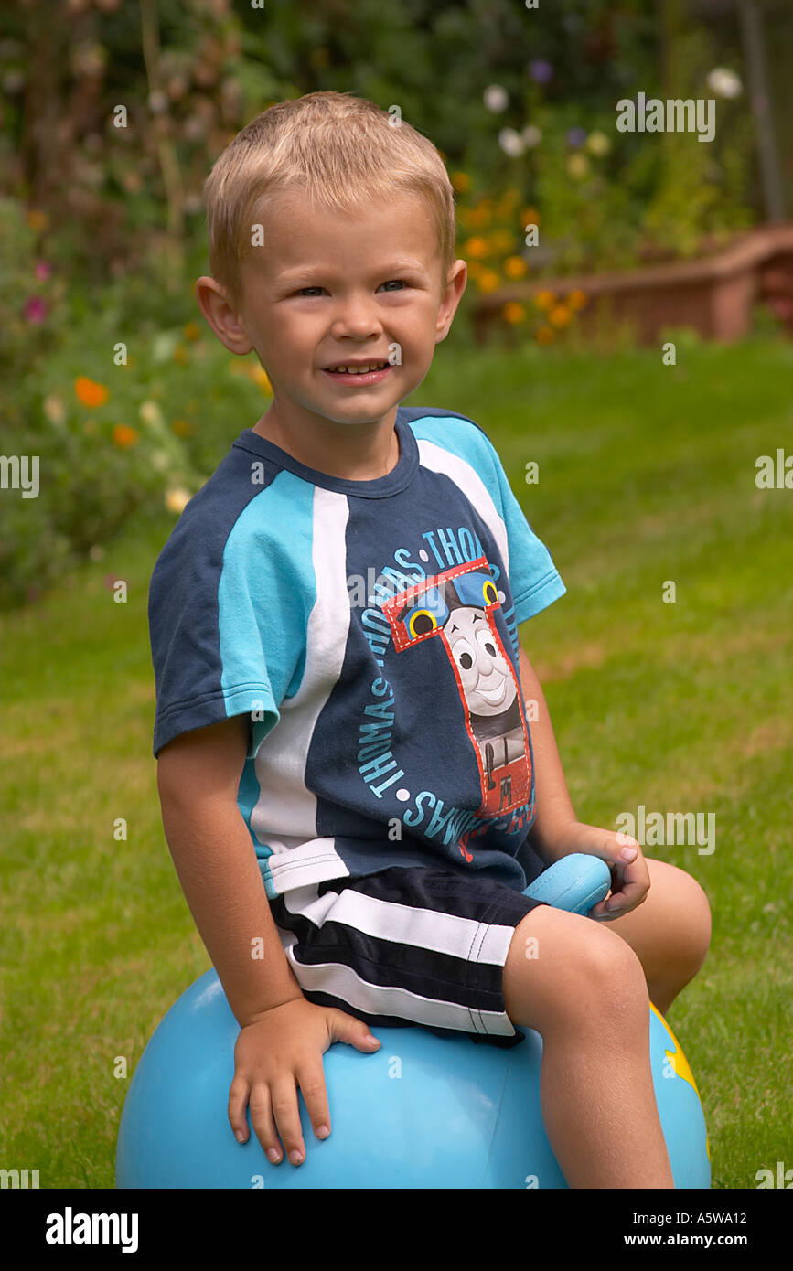 young child sitting on bouncy ball Stock Photo - Alamy