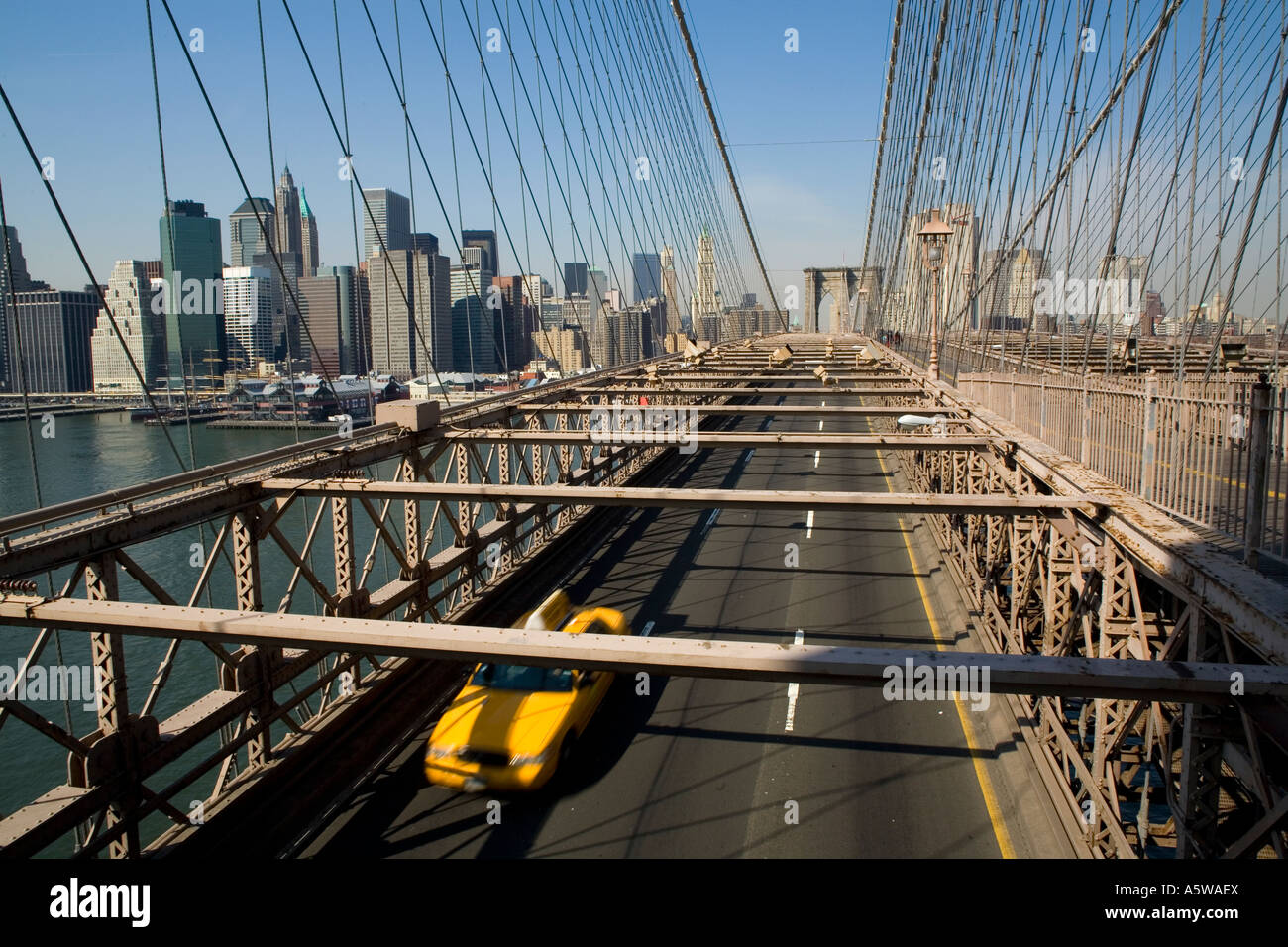 Yellow taxi cab on the Brooklyn Bridge looking towards Manhattan New ...
