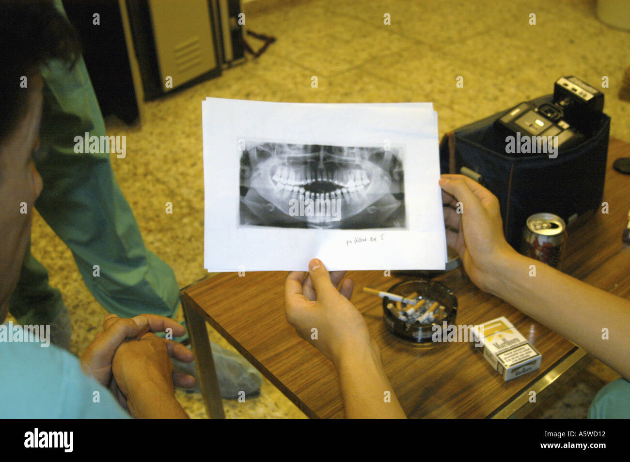 Surgeons looking at a mouth radiography before practicing surgery in an ...